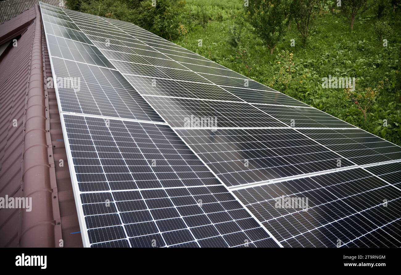 Solar photovoltaic panel system on modern house roof Stock Photo - Alamy