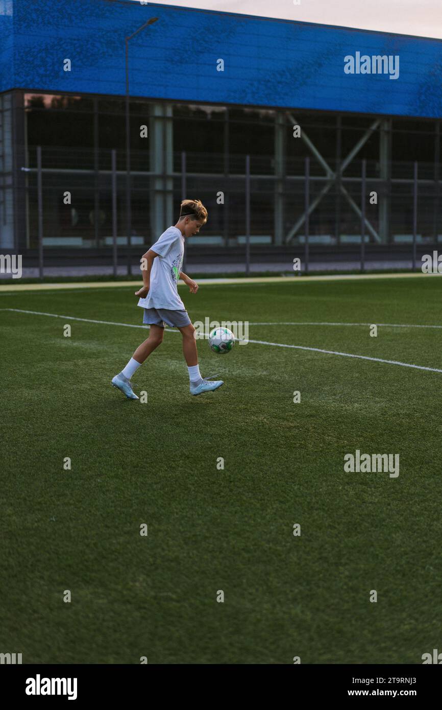 Children boys playing soccer, open school field Stock Photo - Alamy