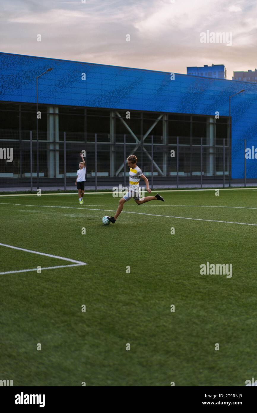 Two young kids playing football hi-res stock photography and images - Alamy