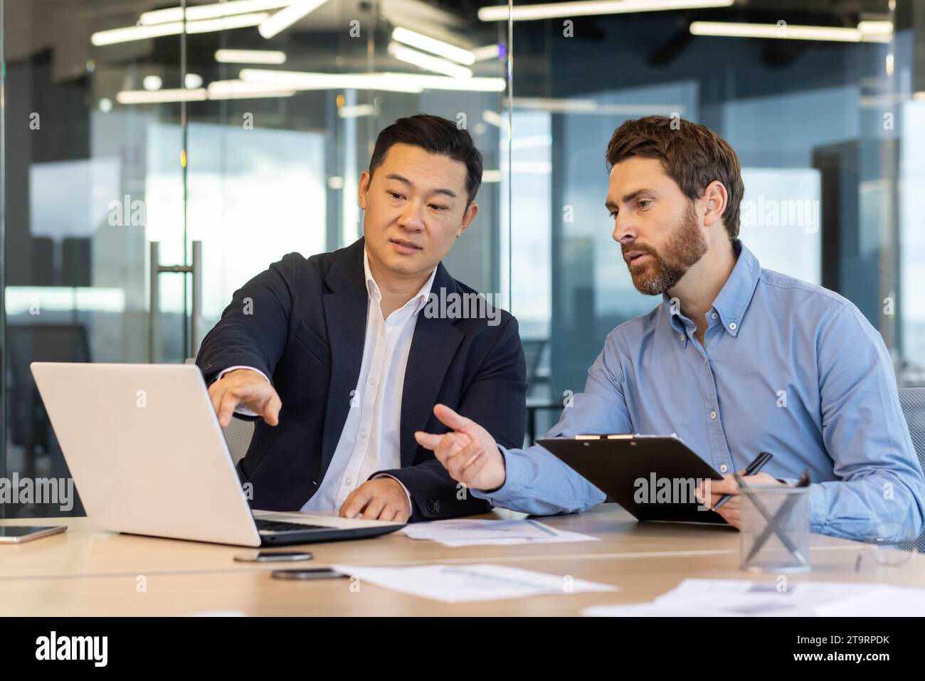 Business meeting, two business people serious concentrated discussing ...