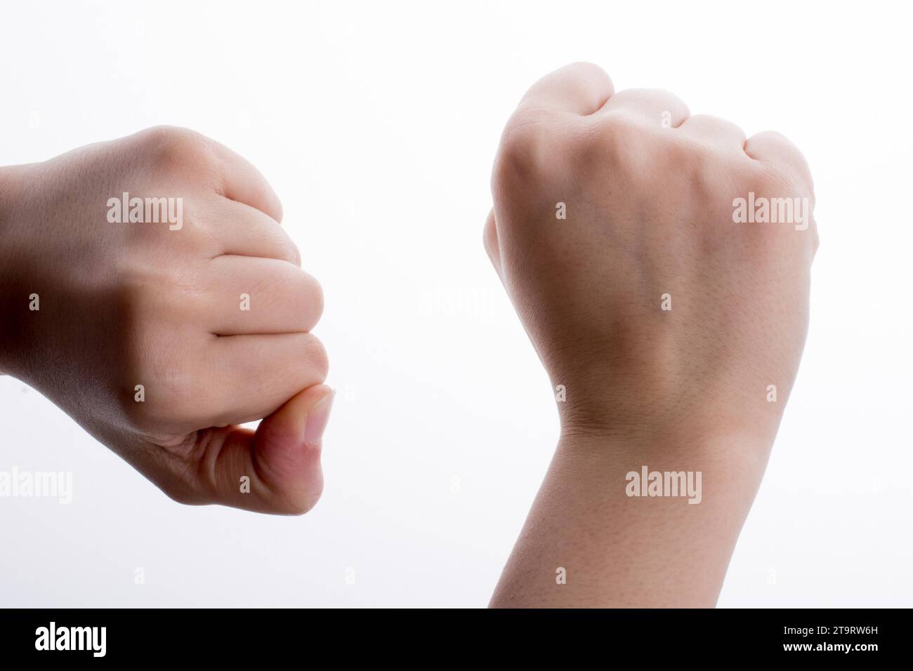 Clenched fists on a white background Stock Photo - Alamy