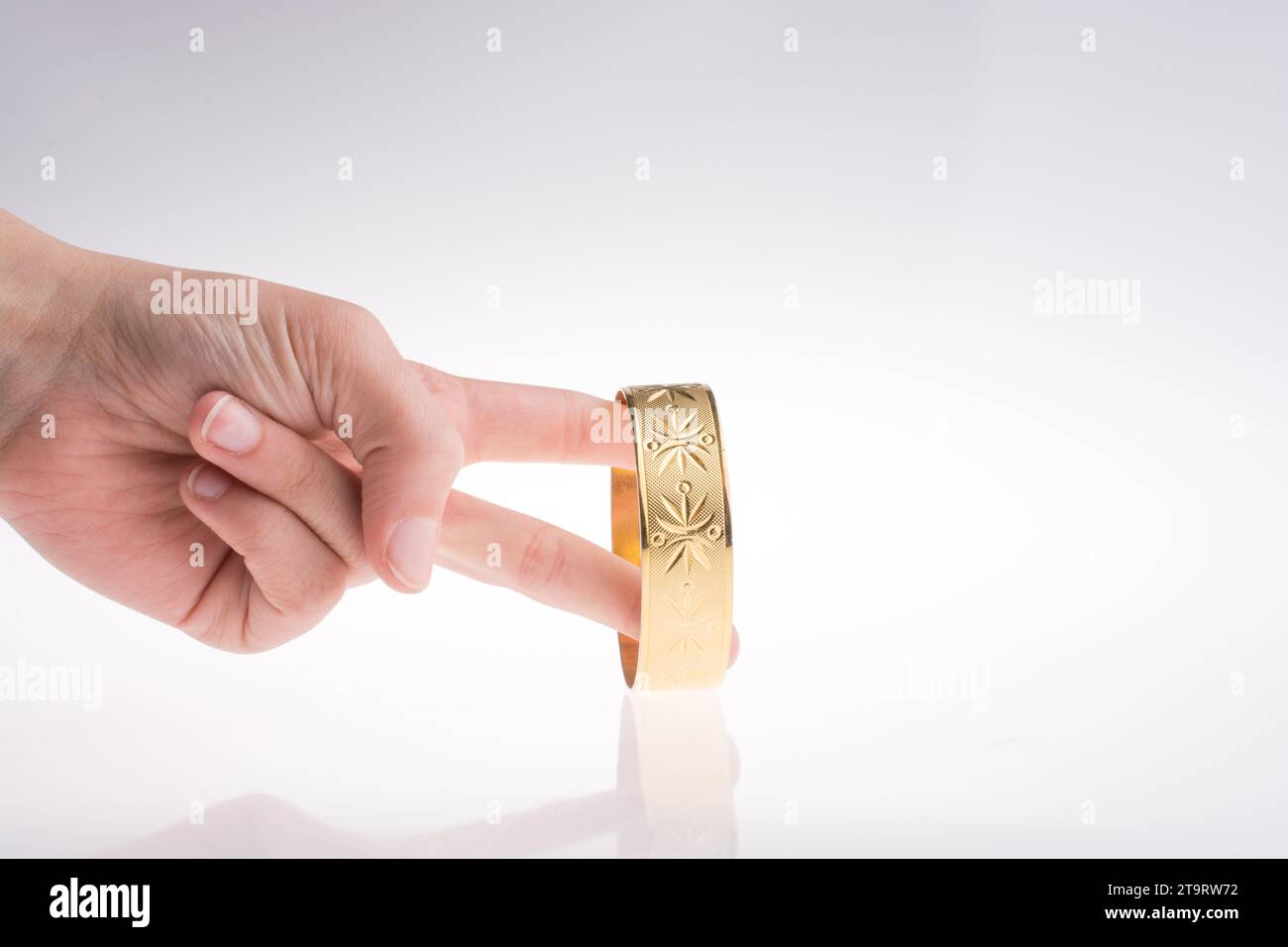 Hand with a golden bracelet on a white background Stock Photo - Alamy