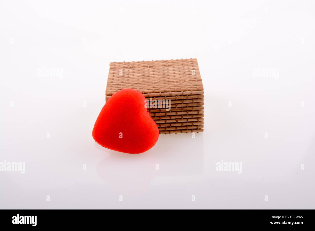 Heart shape object and a gift box on white background Stock Photo - Alamy