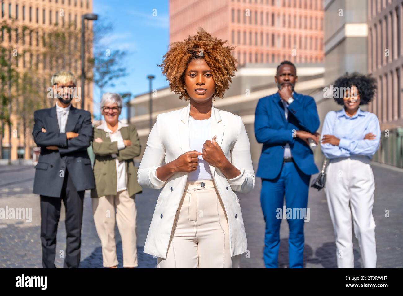 Frontal photo of an african businesswoman standing serious next to ...