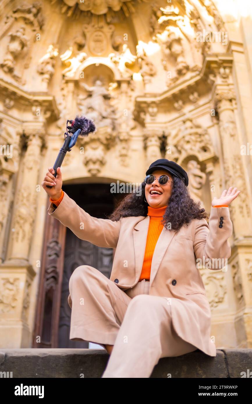 Vertical low angle photo of a female latin influencer posing while ...