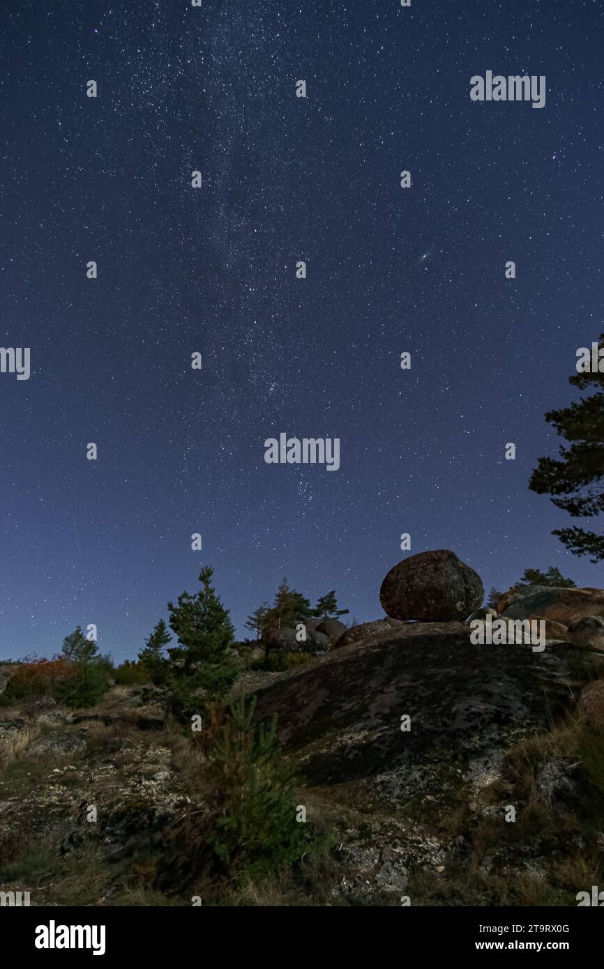 Winter Milky Way and Andromeda galaxy over rocky pure landscape ...