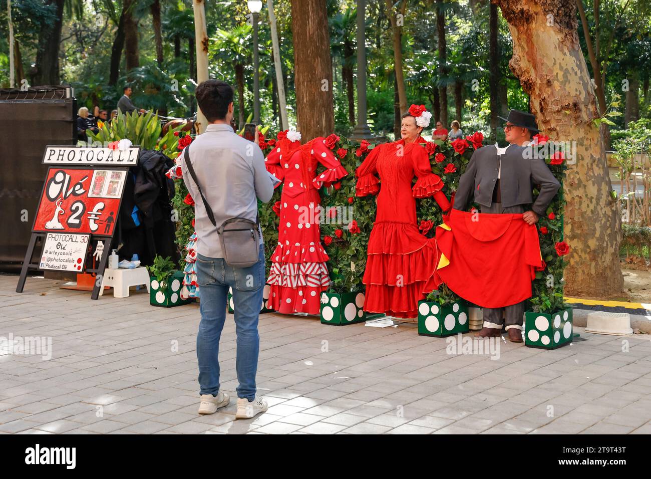 Photographer with a collection of spanish costumes for tourists to be ...