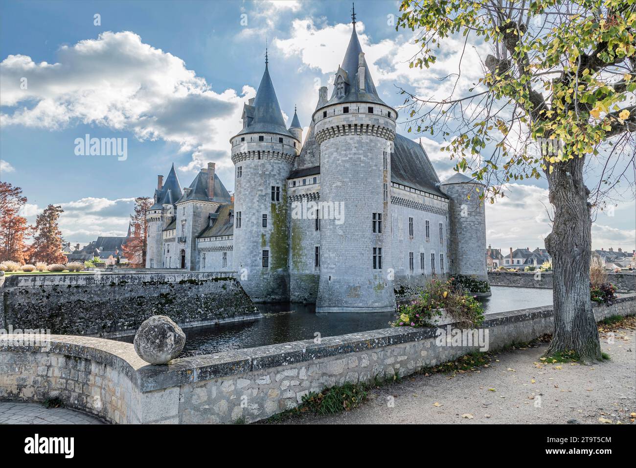 Corner view of an ancient castle across a moat in the cool winter ...