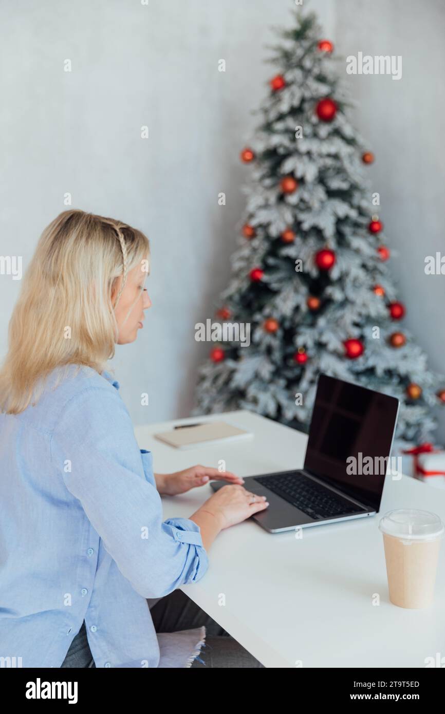 Business woman working behind computer in christmas office Stock Photo ...