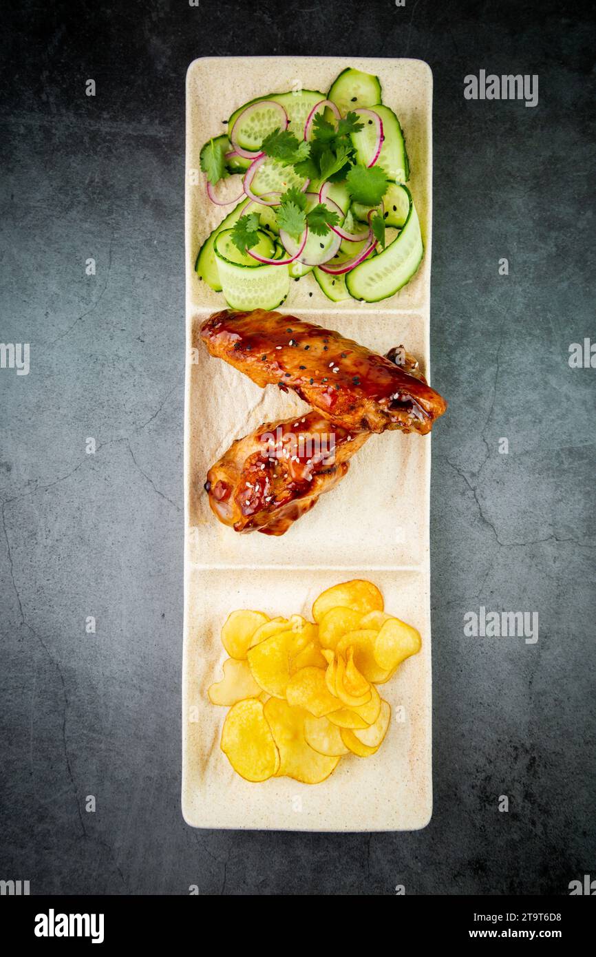 European dish. Chicken in sauce, with fried potatoes and cucumber salad ...