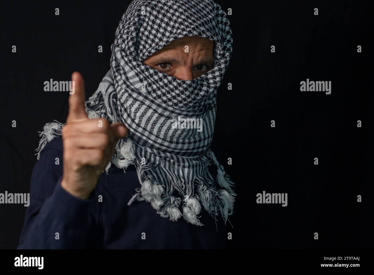 Portrait Adult man with Palestinian scarf put on his head on a black ...