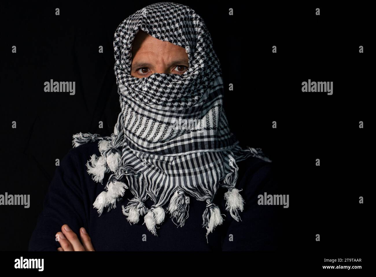 Portrait Adult man with Palestinian scarf put on his head on a black ...
