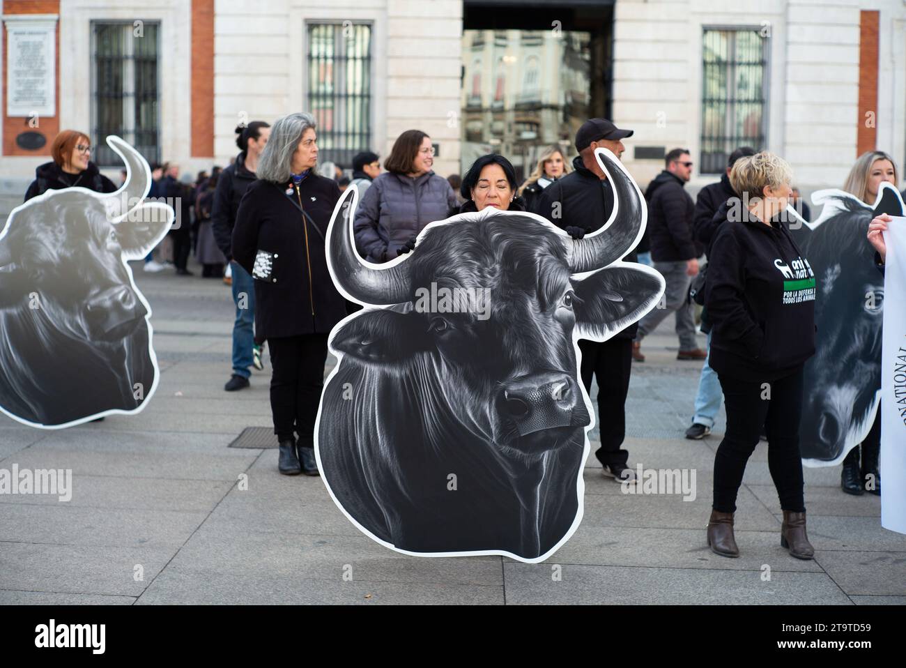 Several people show flags and banners with images of bulls, during a ...