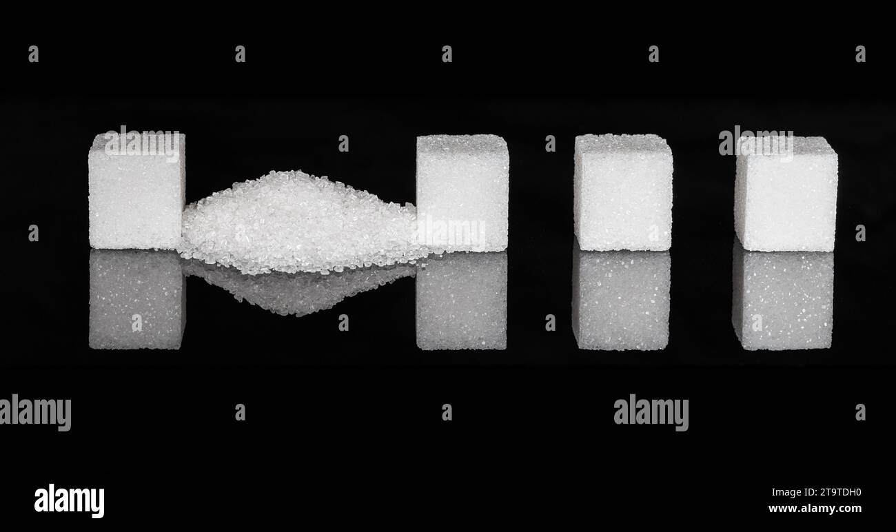 our cubes of refined sugar with a bunch of granulated sugar between ...