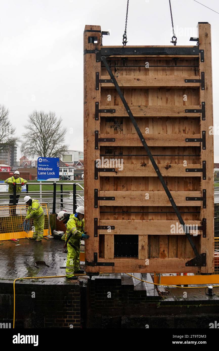 Handcrafted lock gates made from oak are craned into position at the ...