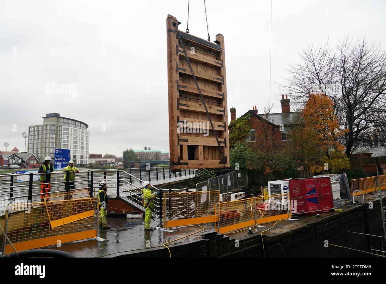 Handcrafted lock gates made from oak are craned into position at the ...