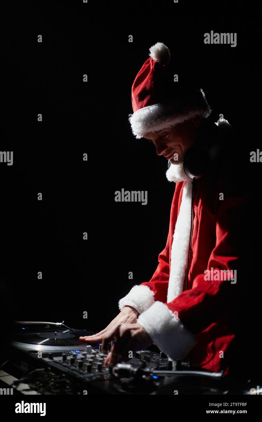 Hip hop DJ Santa scratching a record on Christmas party Stock Photo - Alamy