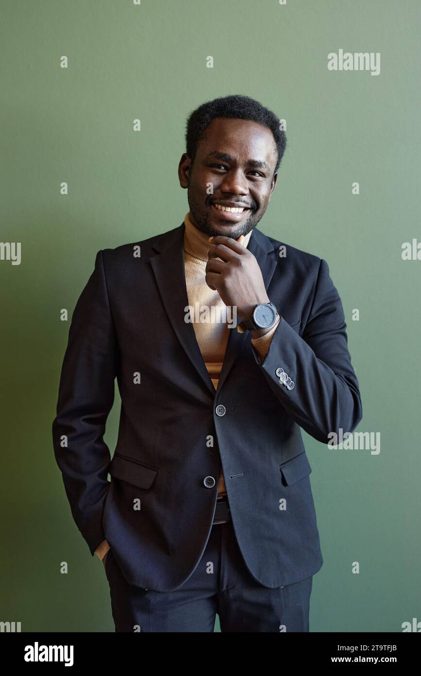Medium long portrait of joyful Black man dressed in elegant suit ...