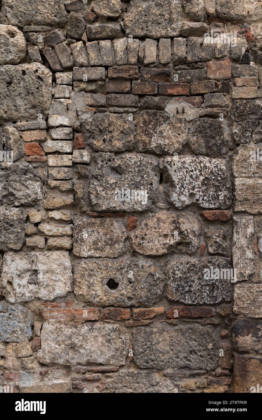 Textured, abstract pattern formed by old, weathered brick and stone ...