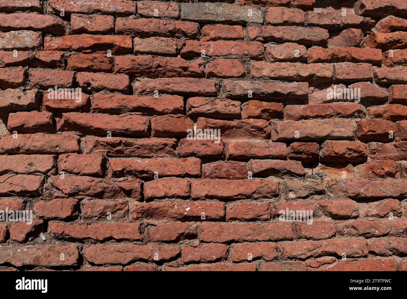 Textured, abstract pattern formed by old, weathered, red brick masonry ...