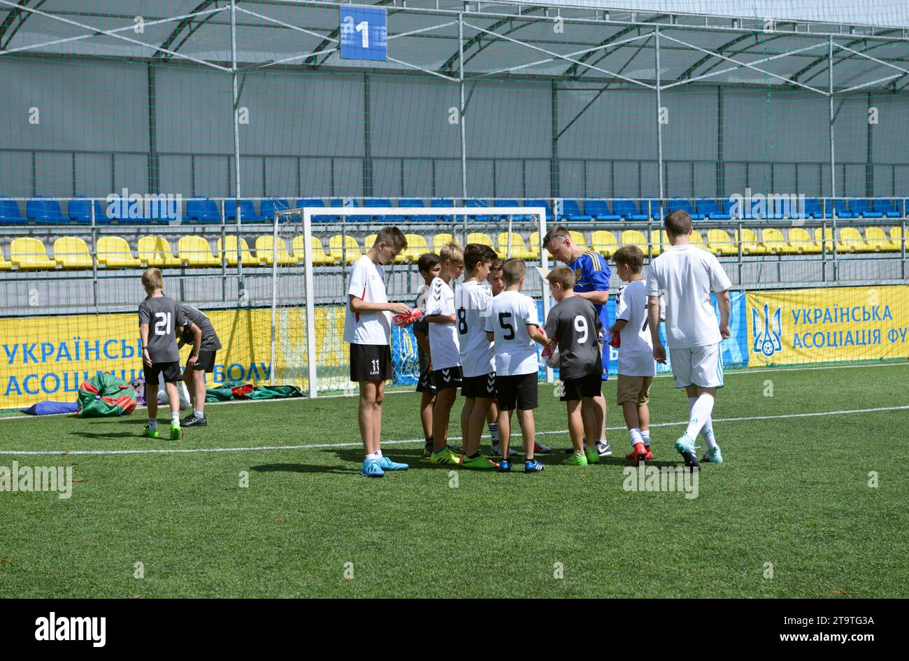 Man coach communicating analyzing the game with team of boys in ...