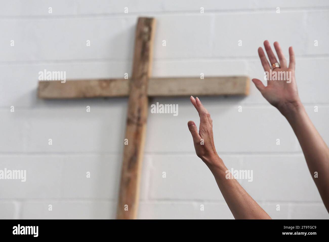 Church hands worship in front of the Holy Cross Stock Photo - Alamy