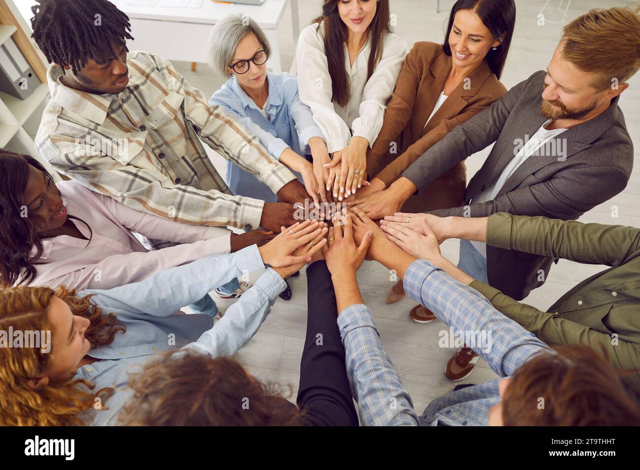 Top view photo of diverse business people putting their arms together in stack Stock Photo - Alamy