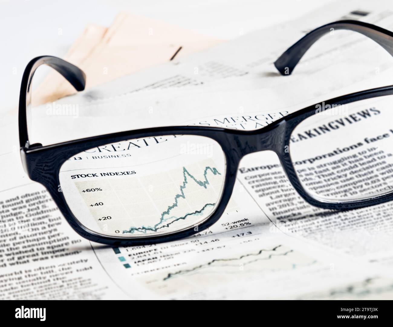 financial chart and graph of stock indexes see through glasses lens on ...