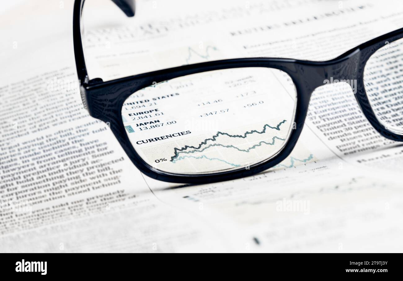 financial chart and graph currencies see through glasses lens on ...