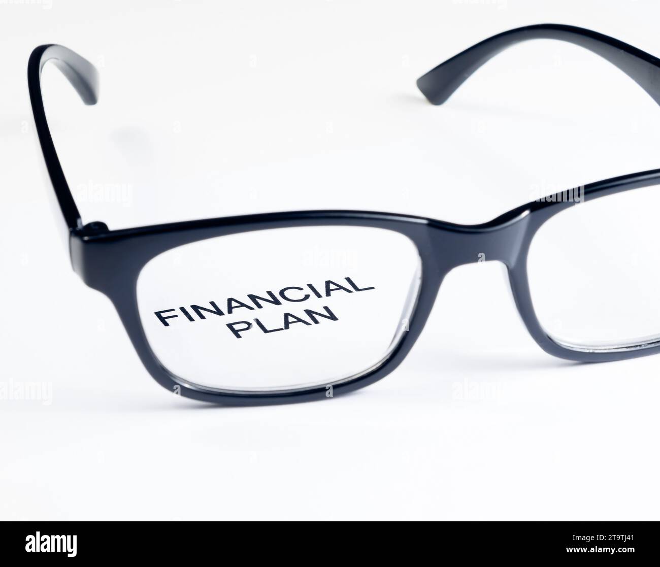 financial plan words see through glasses lens on white background ...