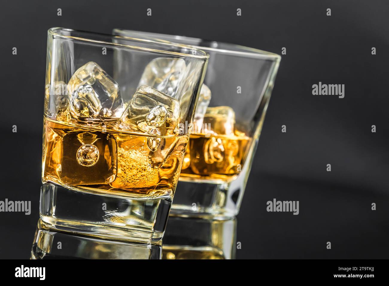 two glasses of whiskey with ice cubes on dark background, time of relax with whisky Stock Photo ...