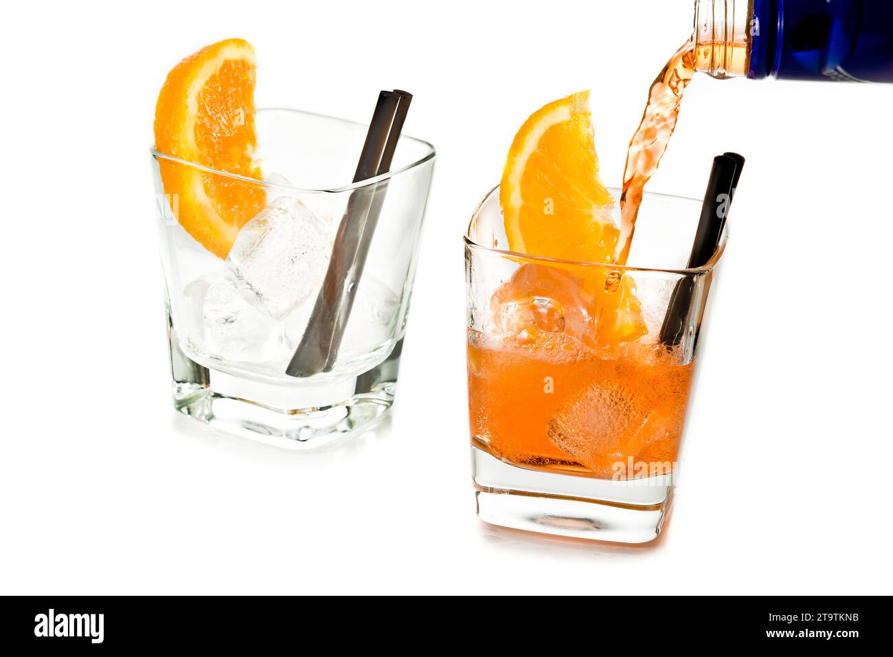 barman pouring spritz aperitif aperol cocktail in two glasses with ...