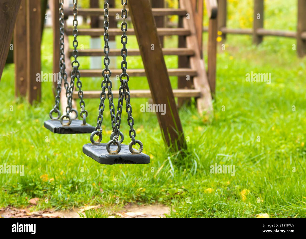 empty swings at playground for child, on green meadow background Stock ...