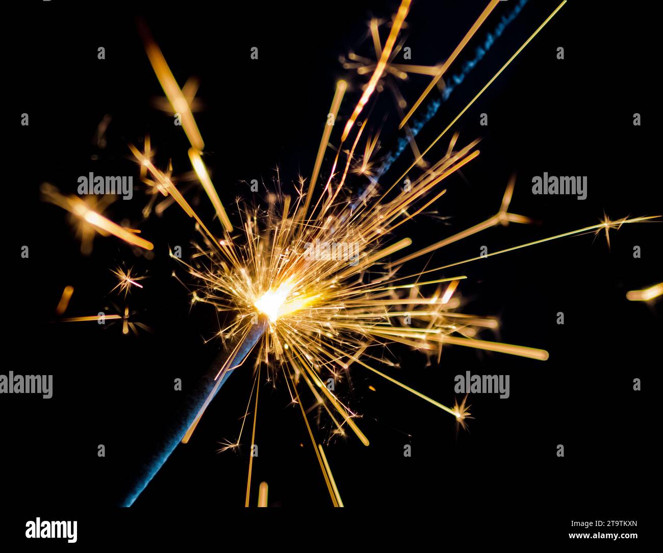 close-up of firework sparkler burning on black background ...