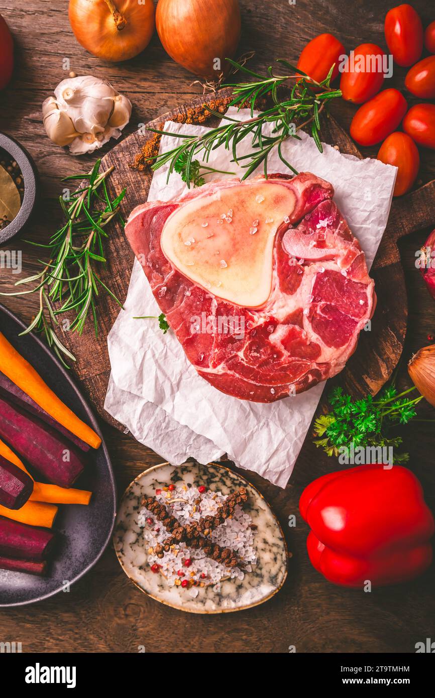 Raw beef meat shank steak, with ingredients for preparation of ossobuco ...