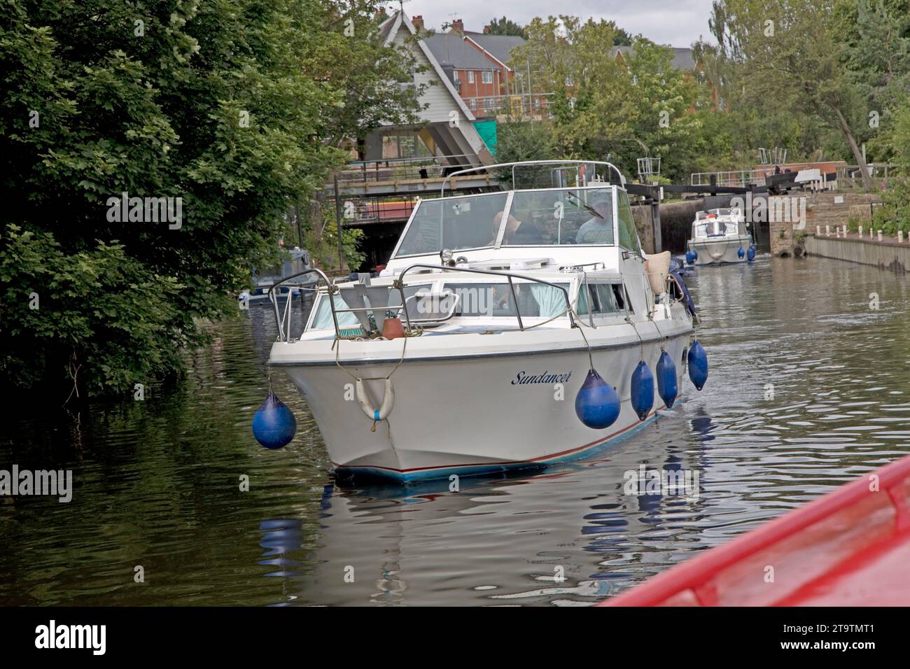 White motor launch pleasure boat just passed through Lock on River Avon ...
