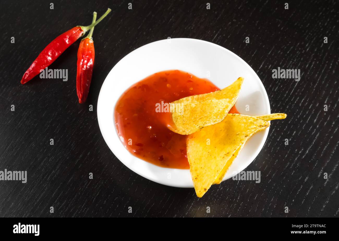 crisp corn nachos with spicy hot tomato sauce as a snack or appetizer ...