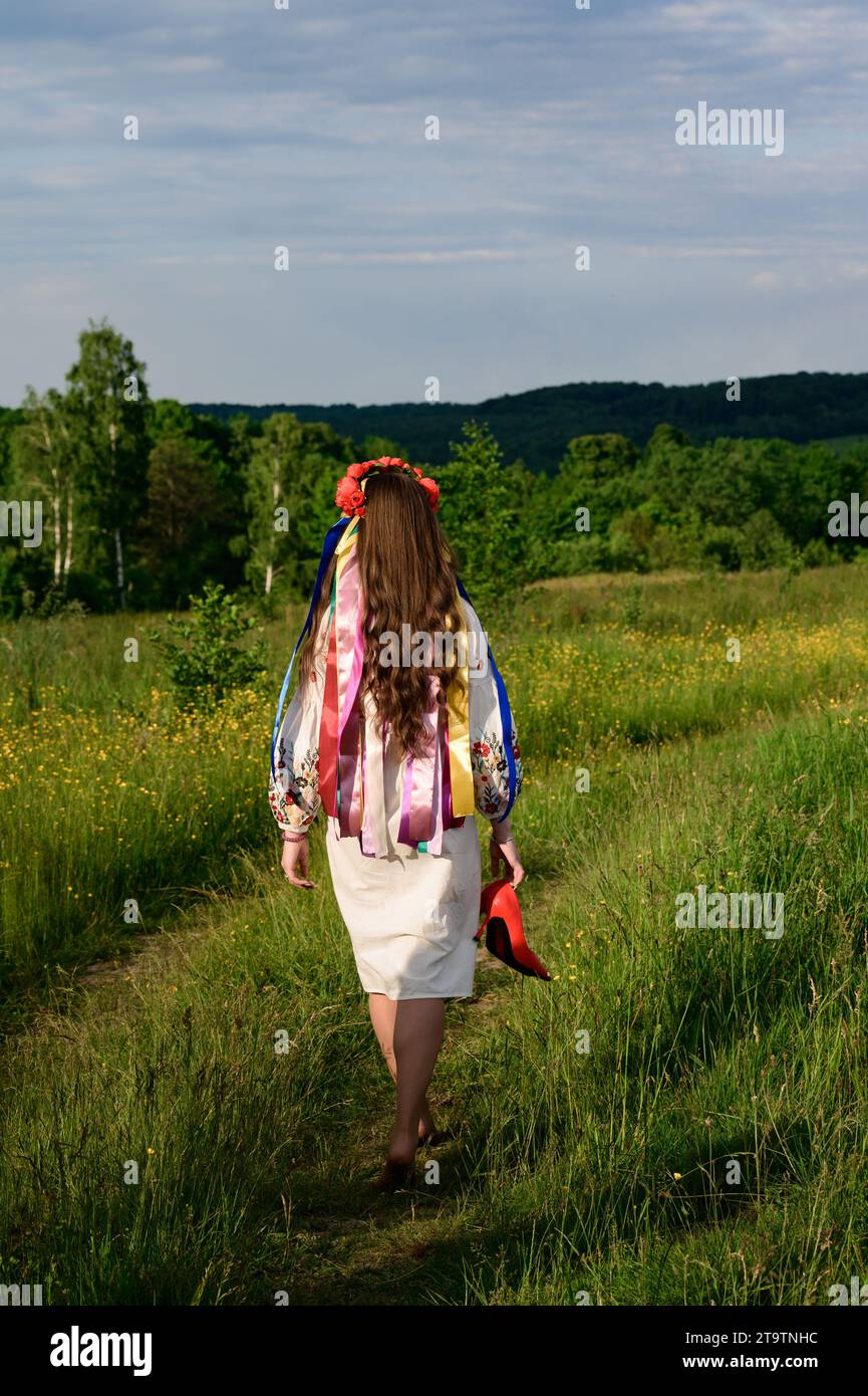 The girl, with her back turned and dressed in Ukrainian national ...