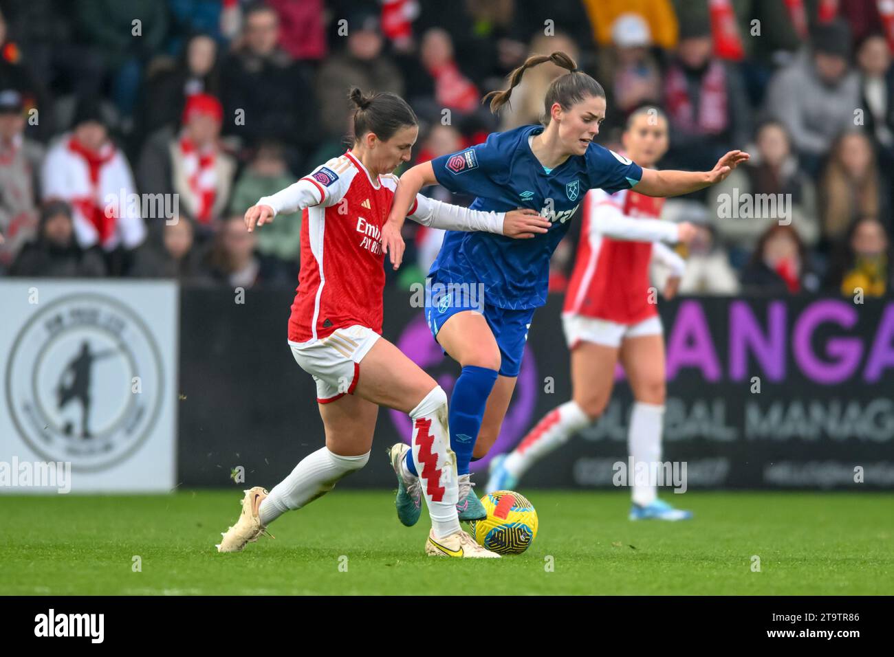 Emma Harries of West Ham Women drives forward with the ball and is ...