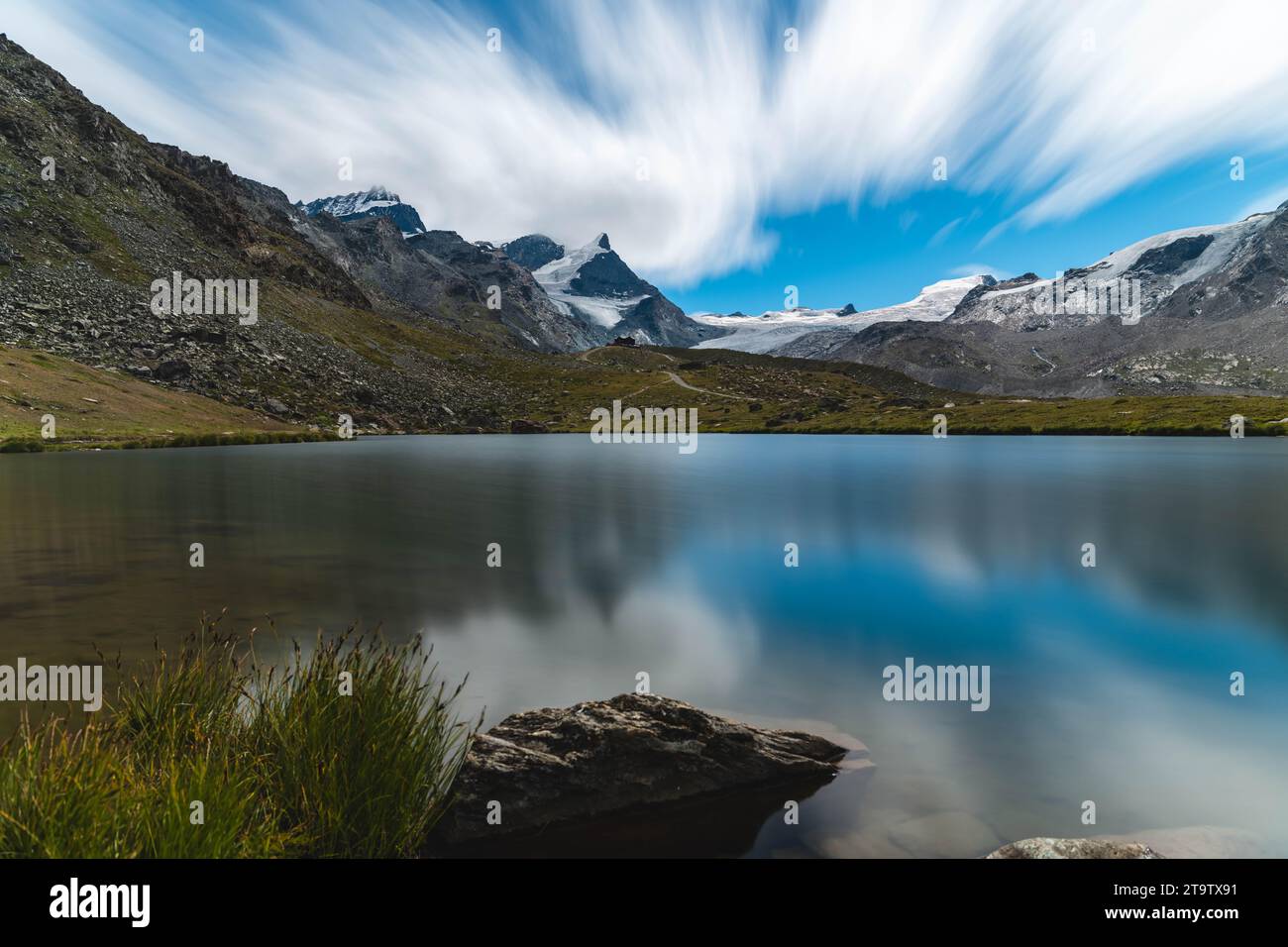 Smooth lake and mountains Stock Photo - Alamy
