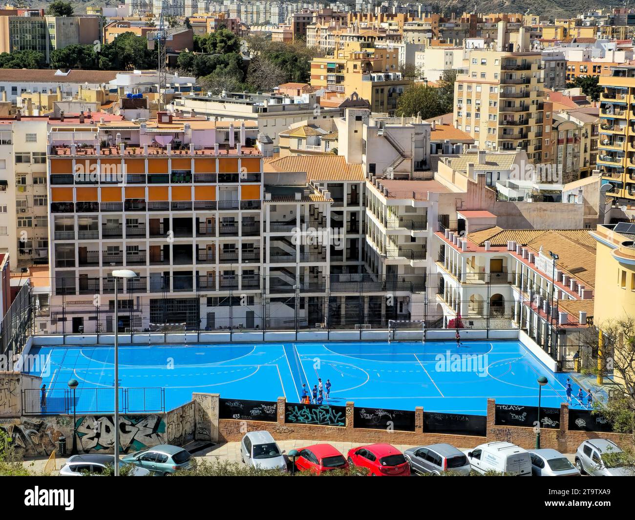 An aerial view of a football field with an urban cityscape in the ...