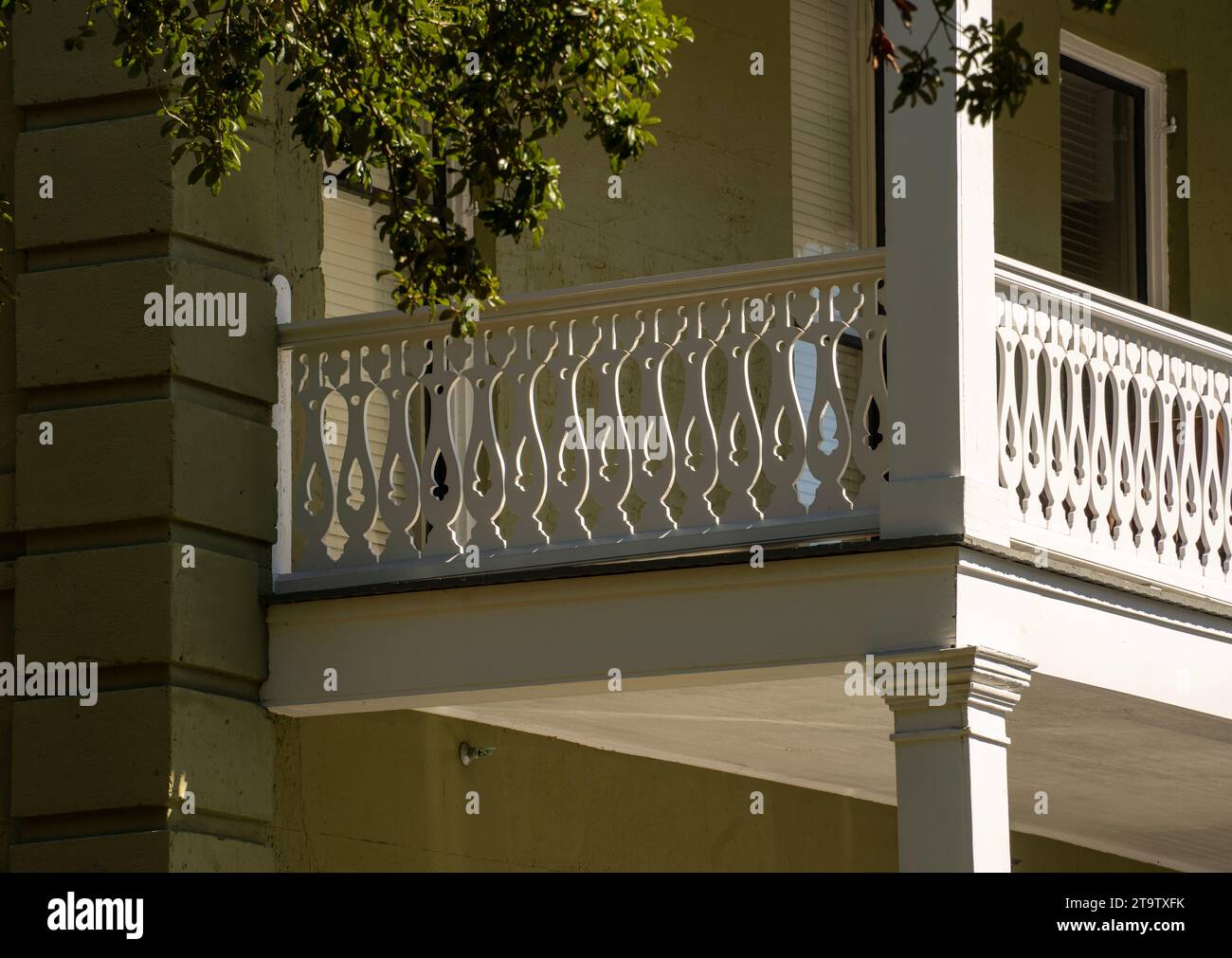 detail of a wood balustrade railing on a upstairs porch on a house in ...