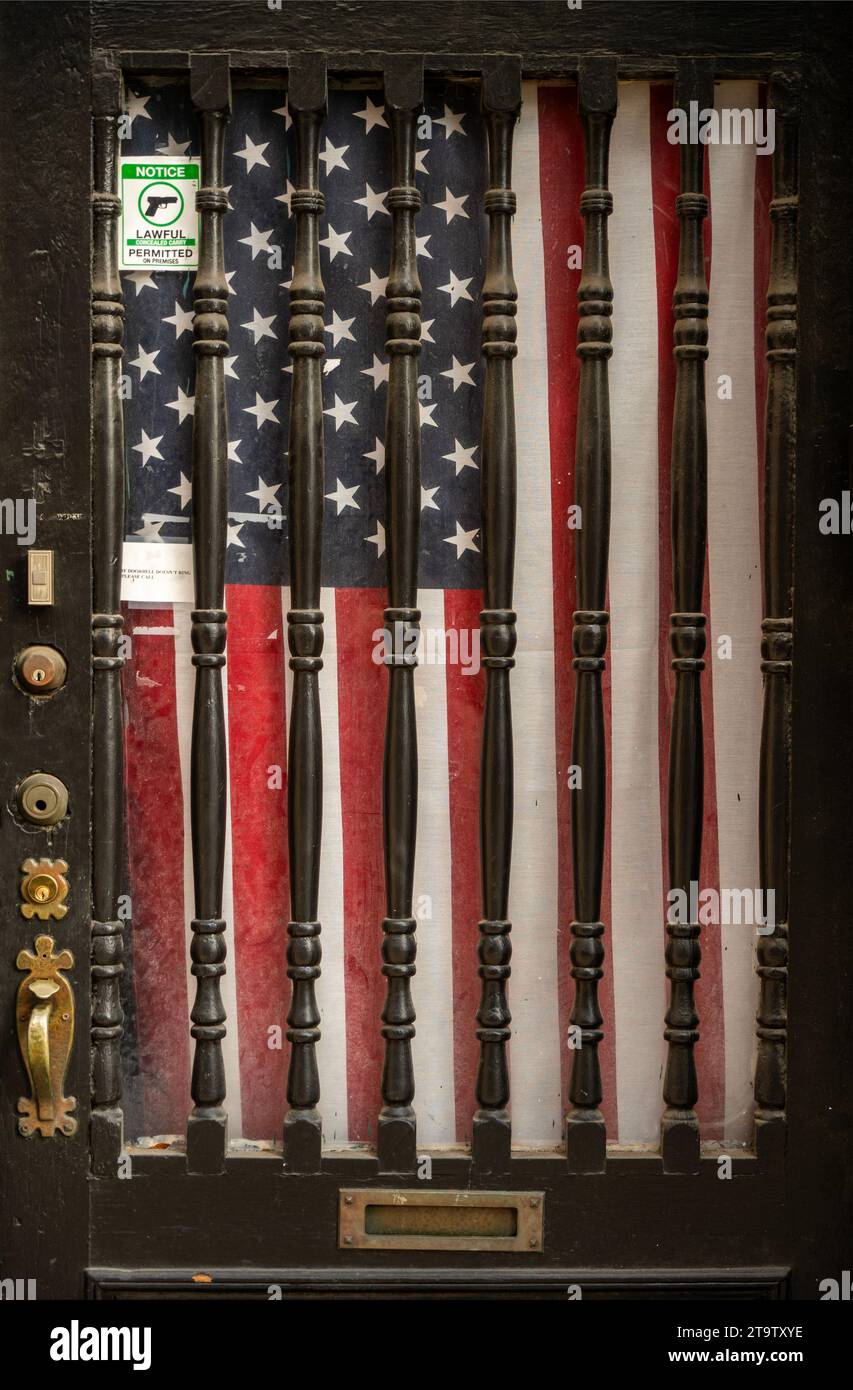 notice guns are allowed in this house sign and American flag hanging in ...
