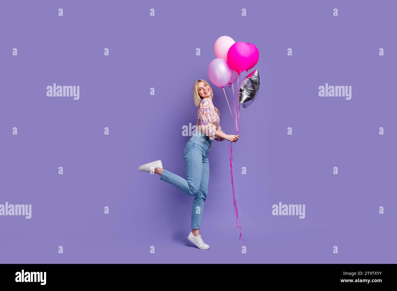 Full body profile photo of lovely positive lady stand one leg arms hold ...