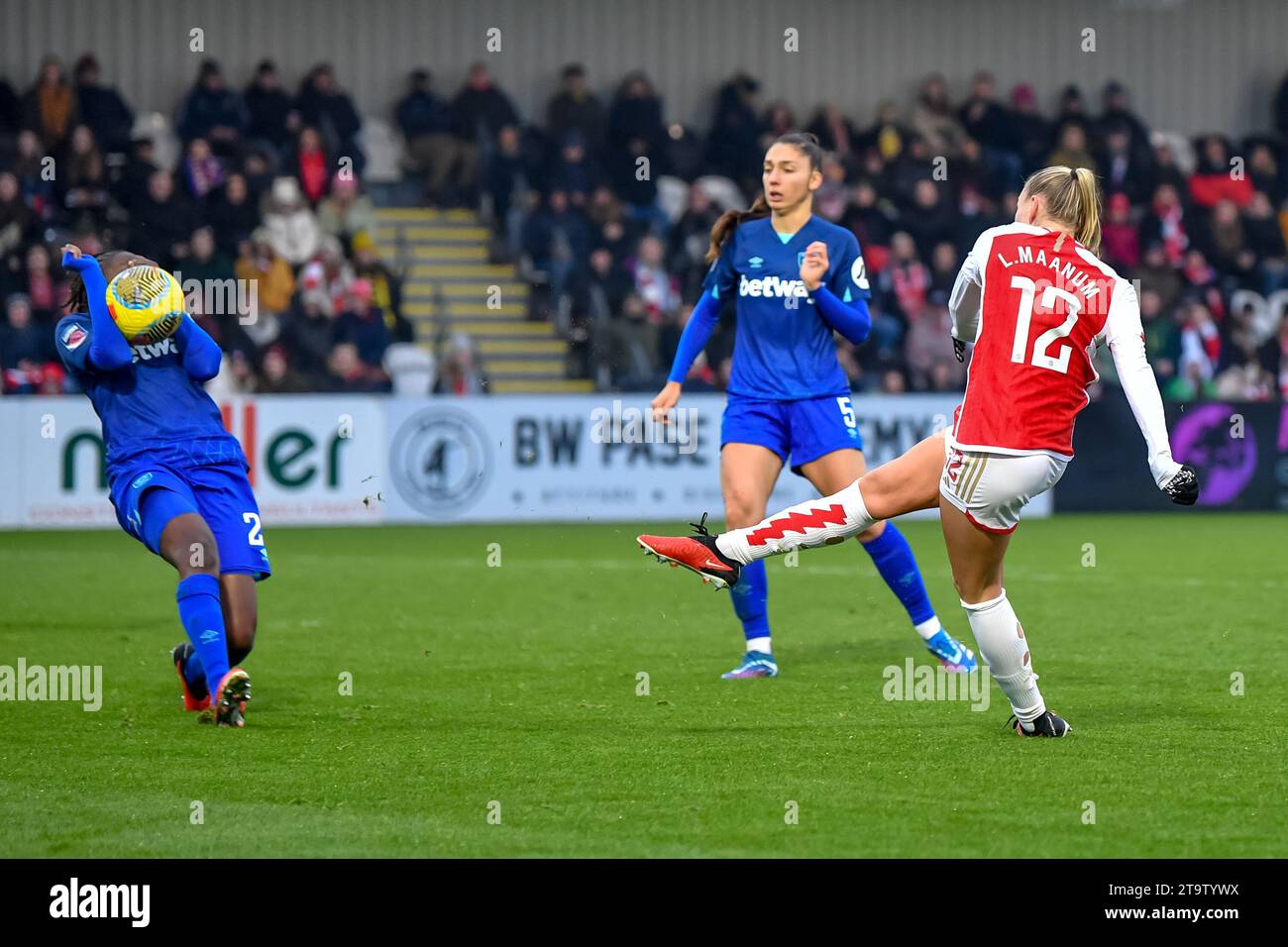 Frida Maanum of Arsenal Women shoots and Hawa Cissoko of West Ham Women ...