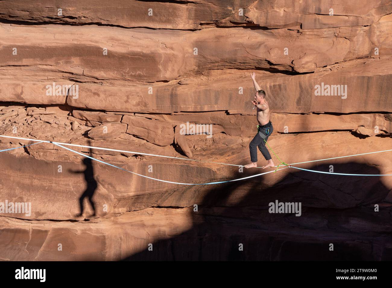 A man on the highline with his shadow on the canyon wall at the GGBY ...
