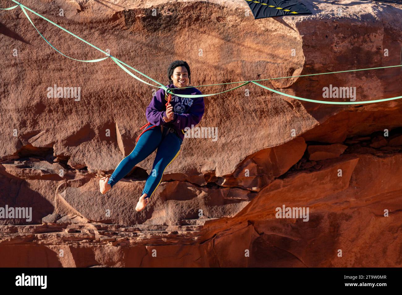 A woman rests on her tether after falling off the highline at the GGBY ...