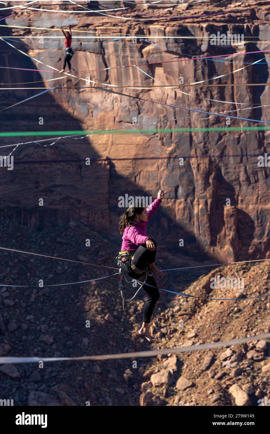 A woman prepares to stand up on the highline over Mineral Canyon at the ...