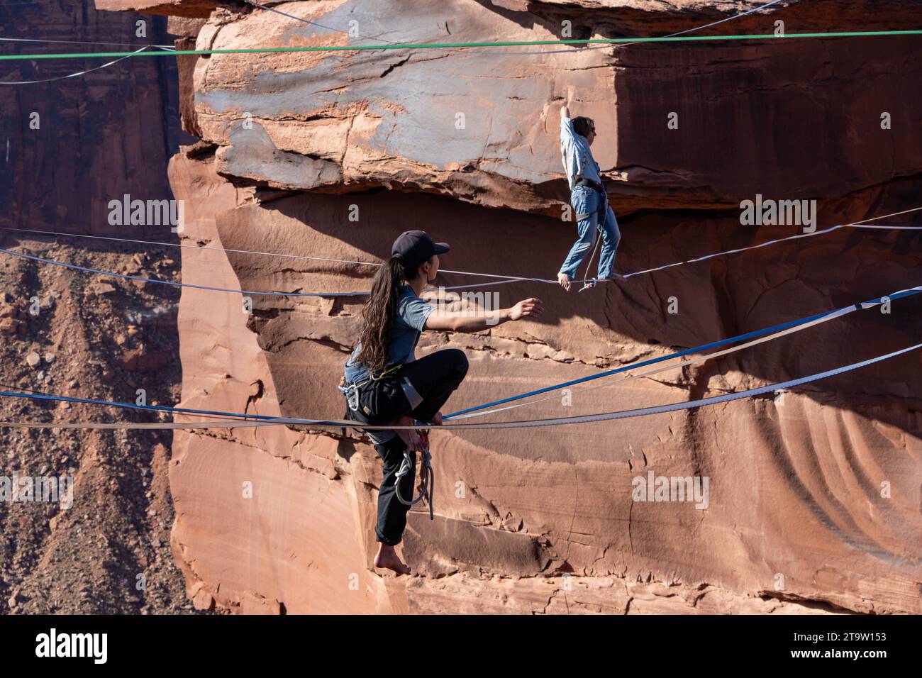 A woman prepares to stand up on the highline over Mineral Canyon at the ...