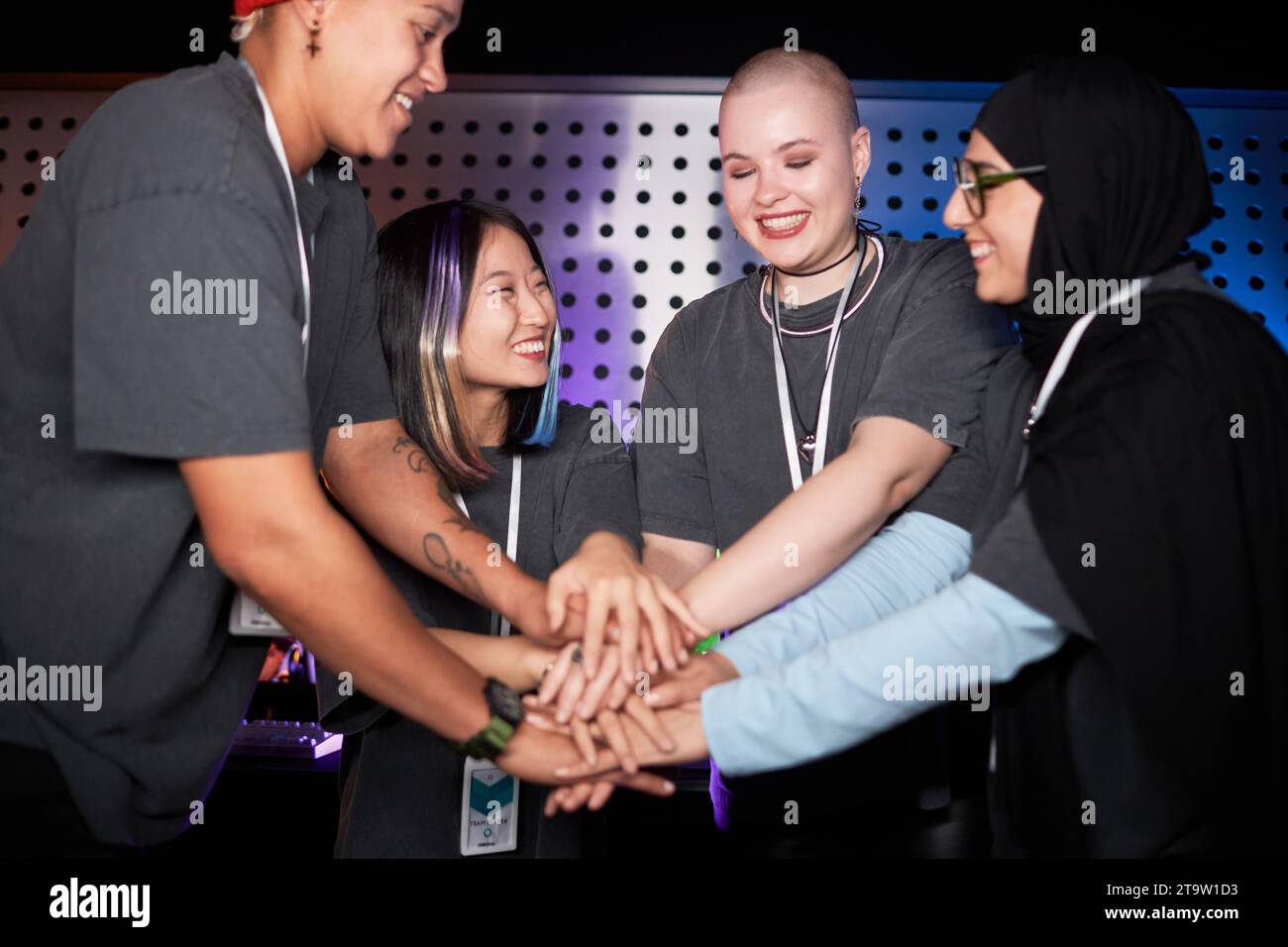 Portrait of multiethnic female team celebrating victory on stage during ...